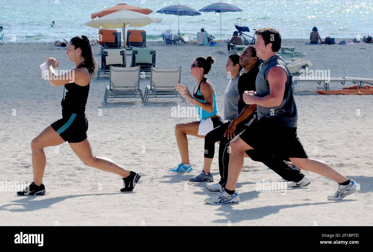 Fitness trainer Marquel Wimbley, left, leads a group of exercise ...