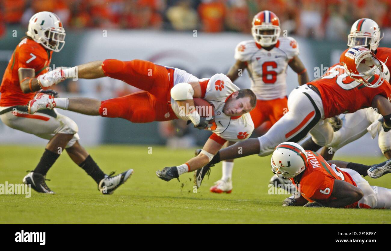 Clemson tight end Michael Palmer gets his helmet taken off after a hit ...