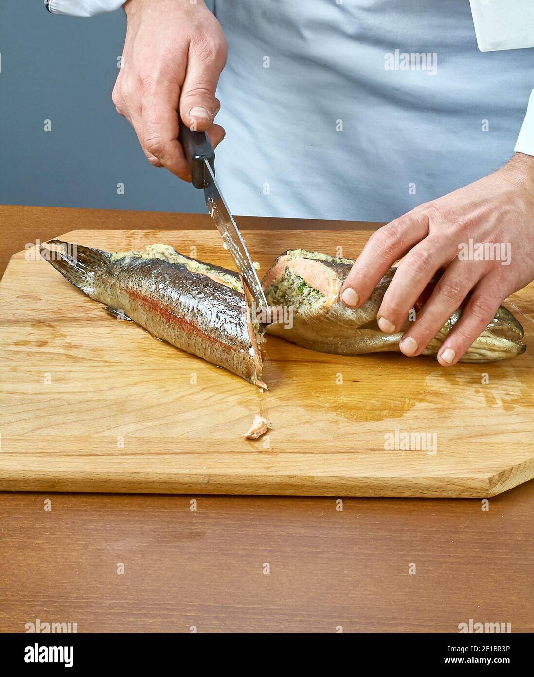 The cook cuts the baked fish a full collection of food recipes Stock ...
