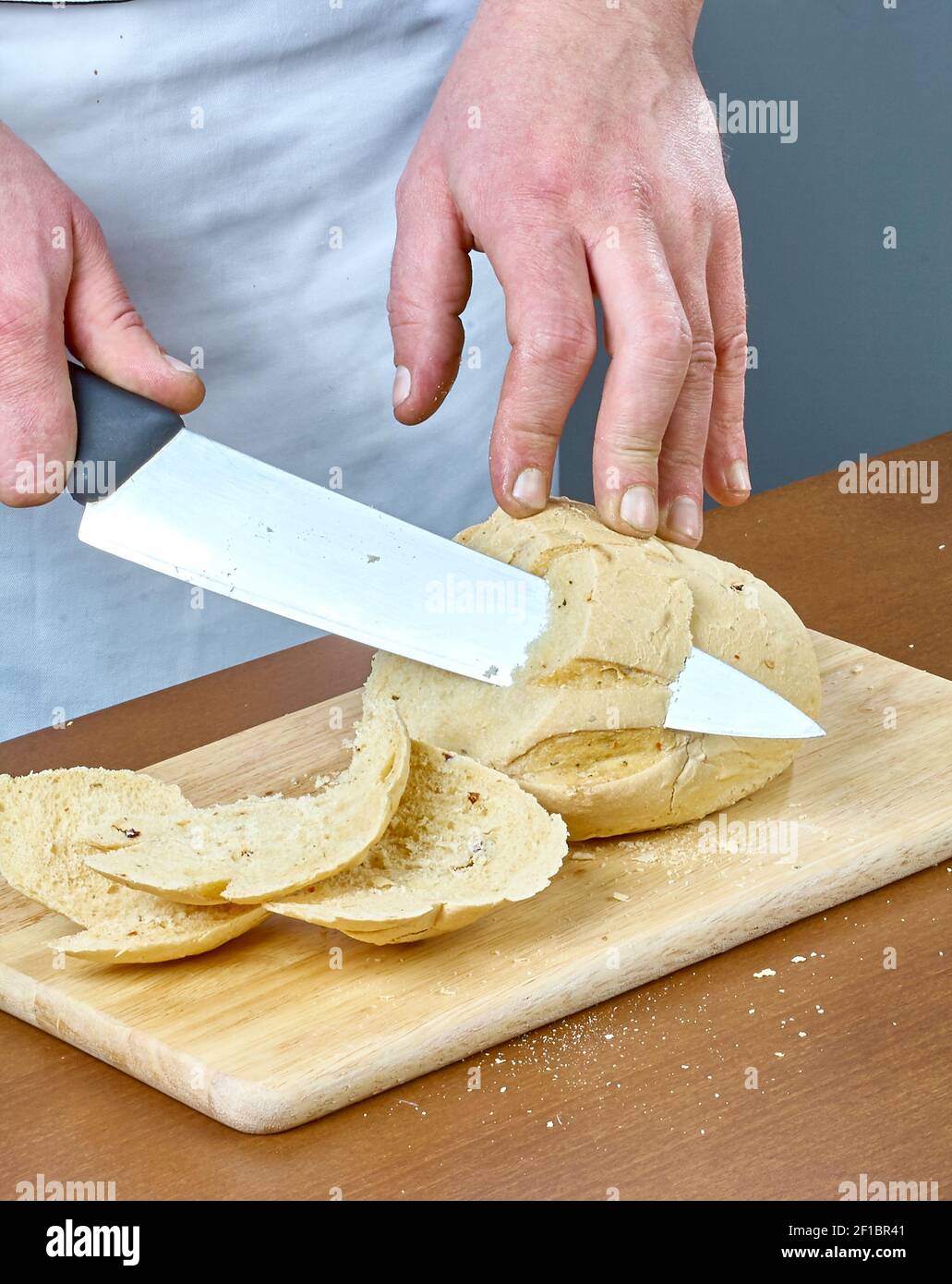 Cook cuts bread for cooking stuffed fish full collection of culinary ...