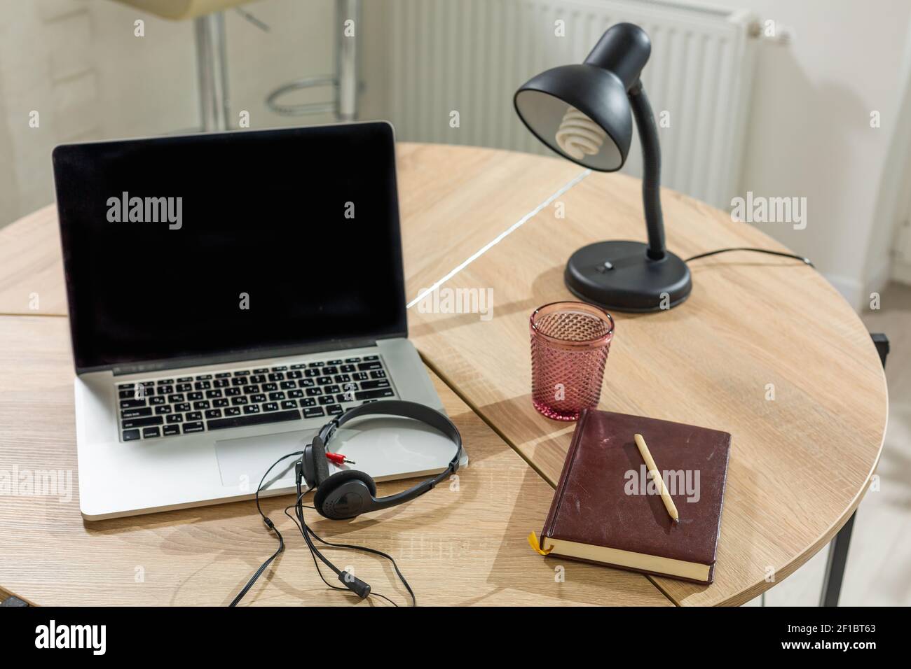 Laptop on table, home interior Stock Photo - Alamy