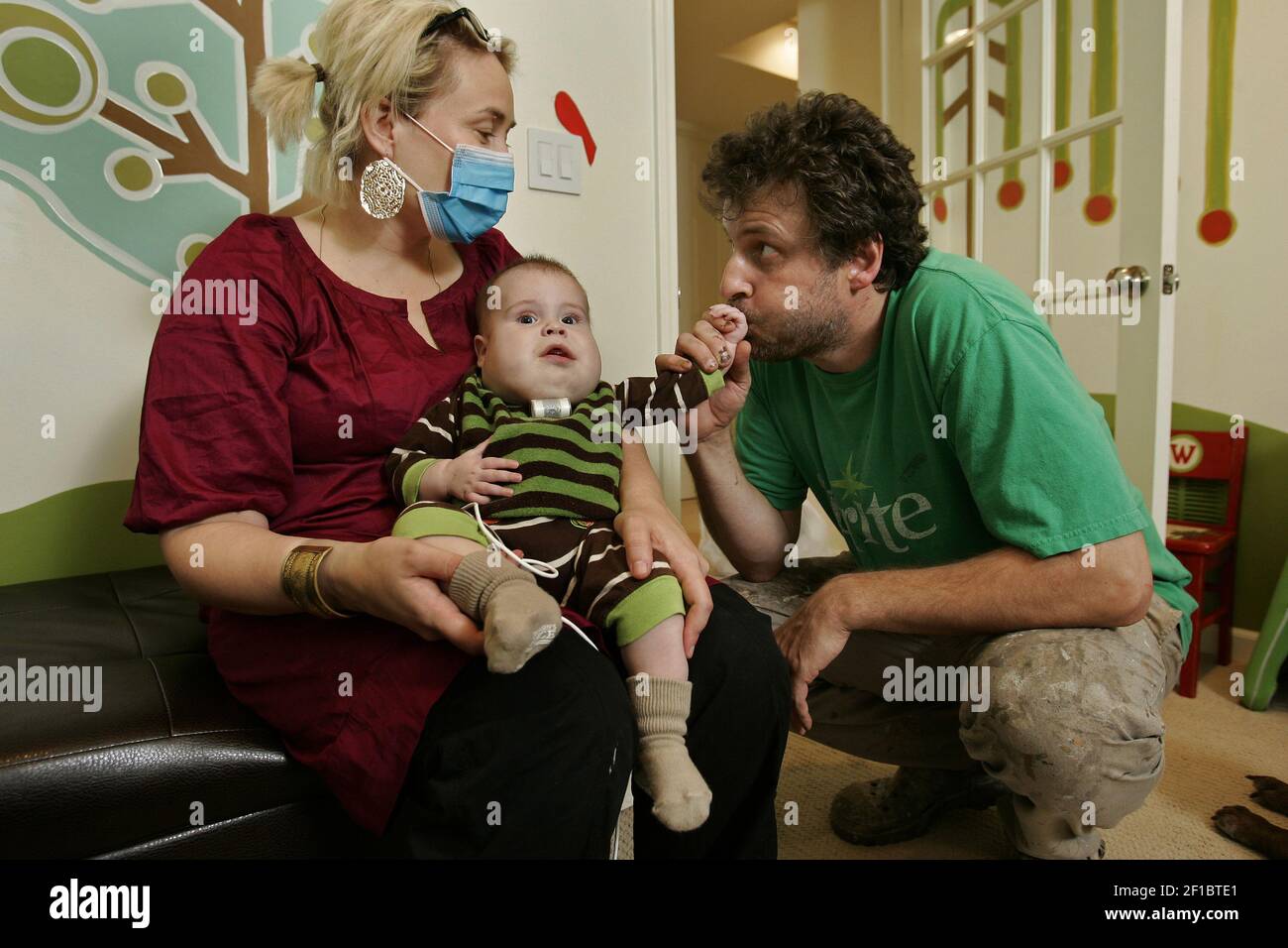 Jennifer Bertrand, left, holds 7-month-old son Winston, who gets a kiss ...