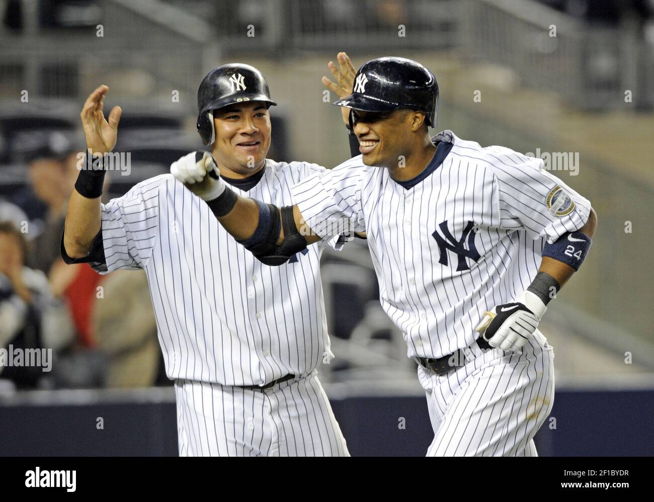 New York Yankees Melky Cabrera, left, and Robinson Cano celebrate after scoring on Cano's grand ...