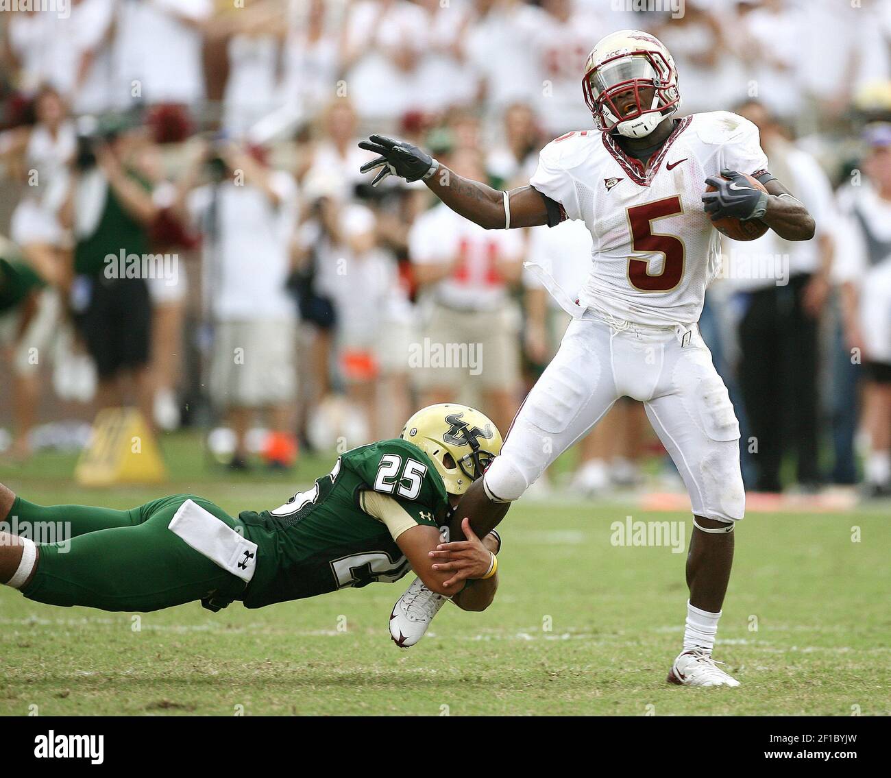 South Florida punter Delbert Alvarado brings down Florida State's Greg ...