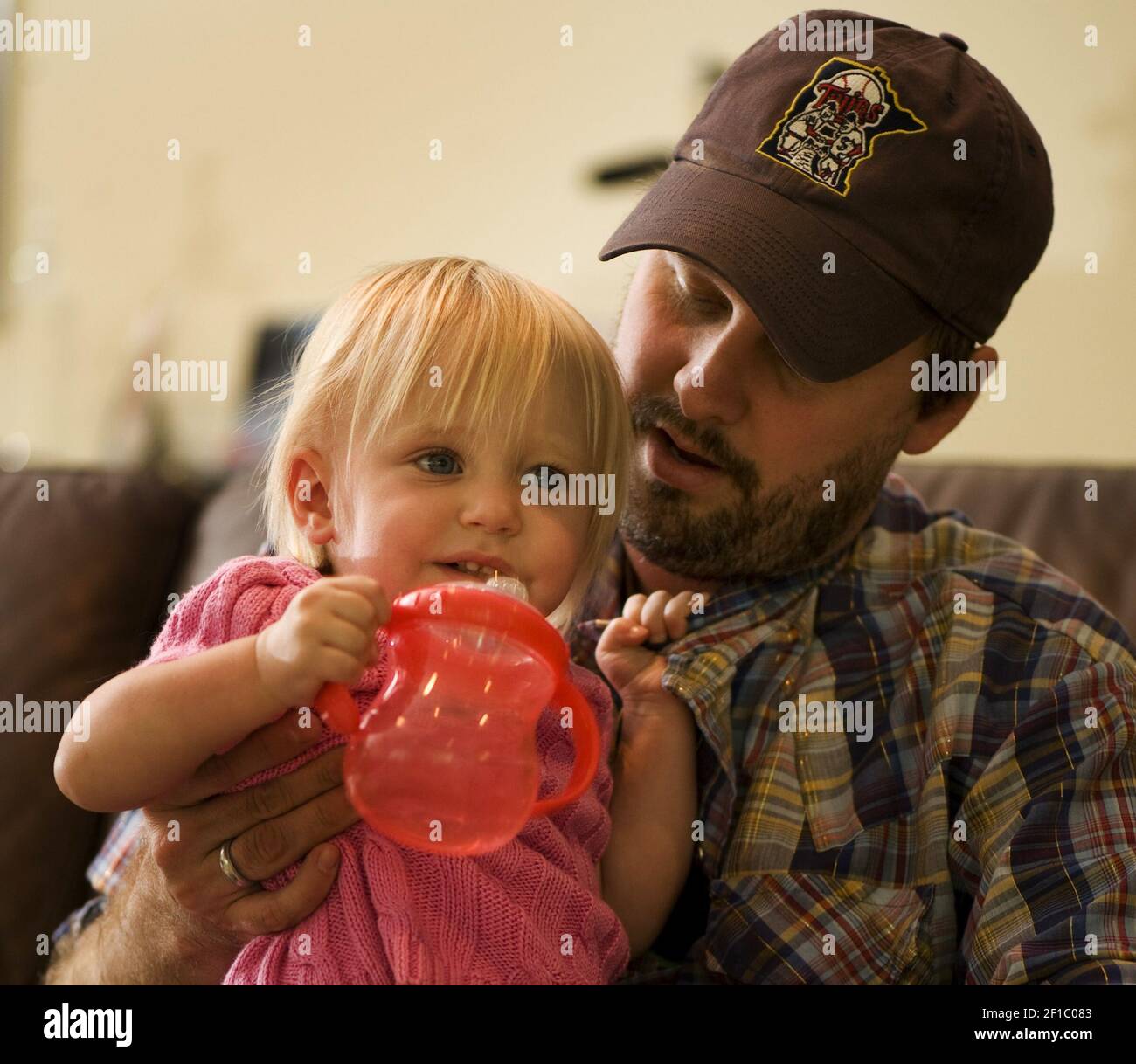 Matt Logelin, right, holds his 18-month-old daughter, Maddy Logelin, at ...