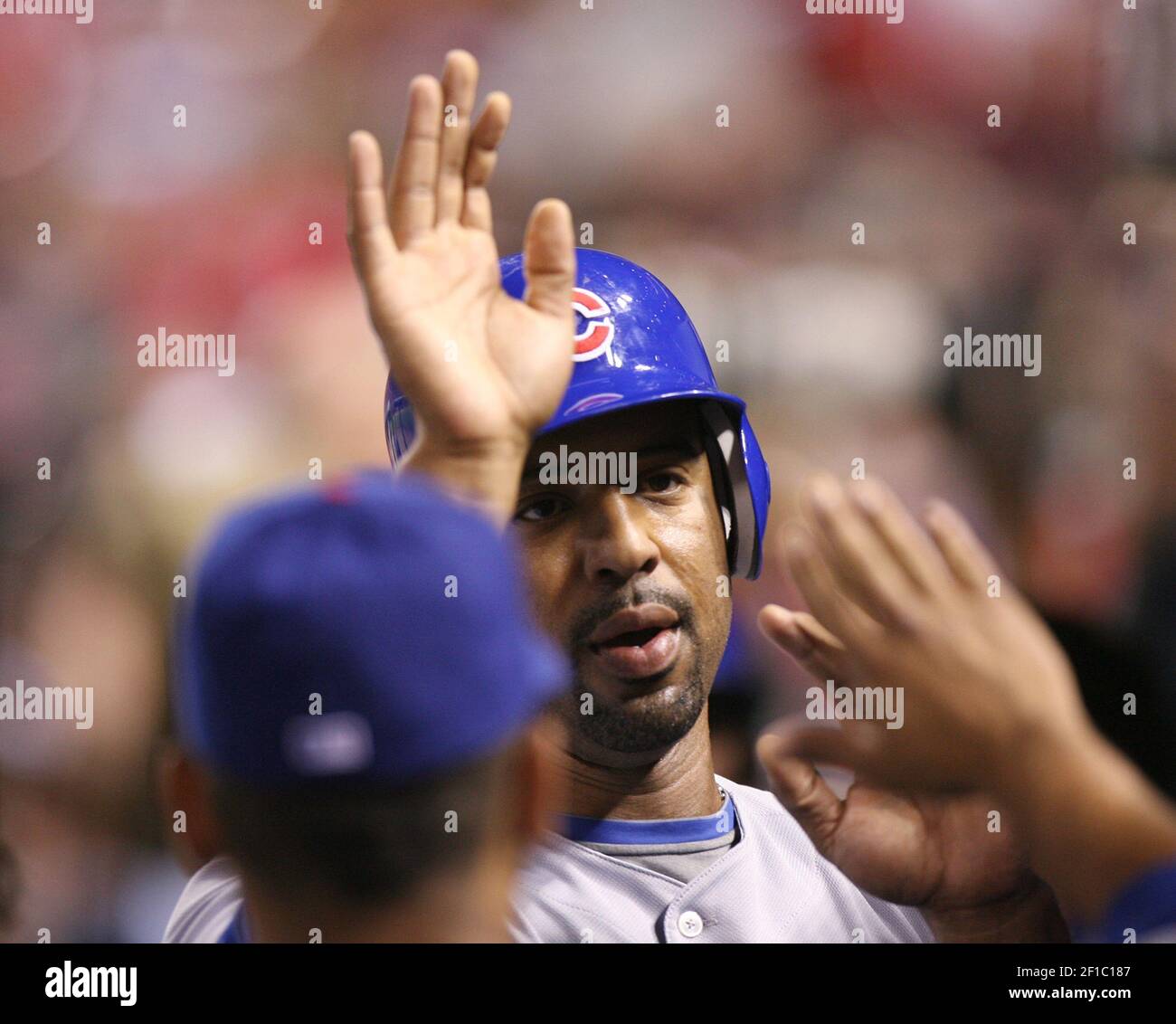 The Chicago Cubs' Derrek Lee is congratulated in the dugout after ...