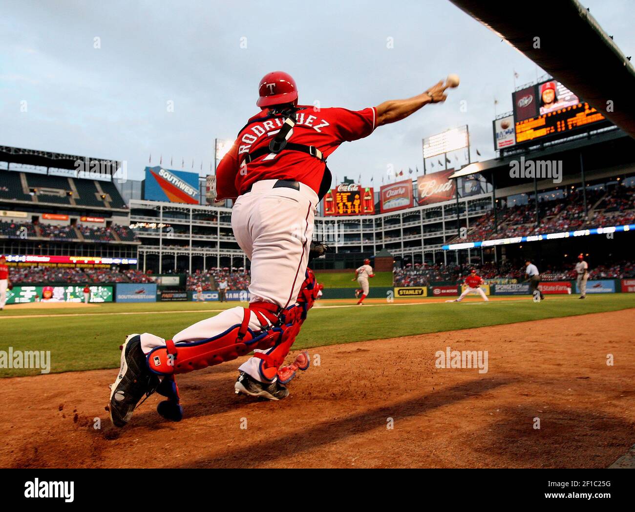 Texas Rangers catcher Ivan Rodriguez fires a throw to first base in an ...