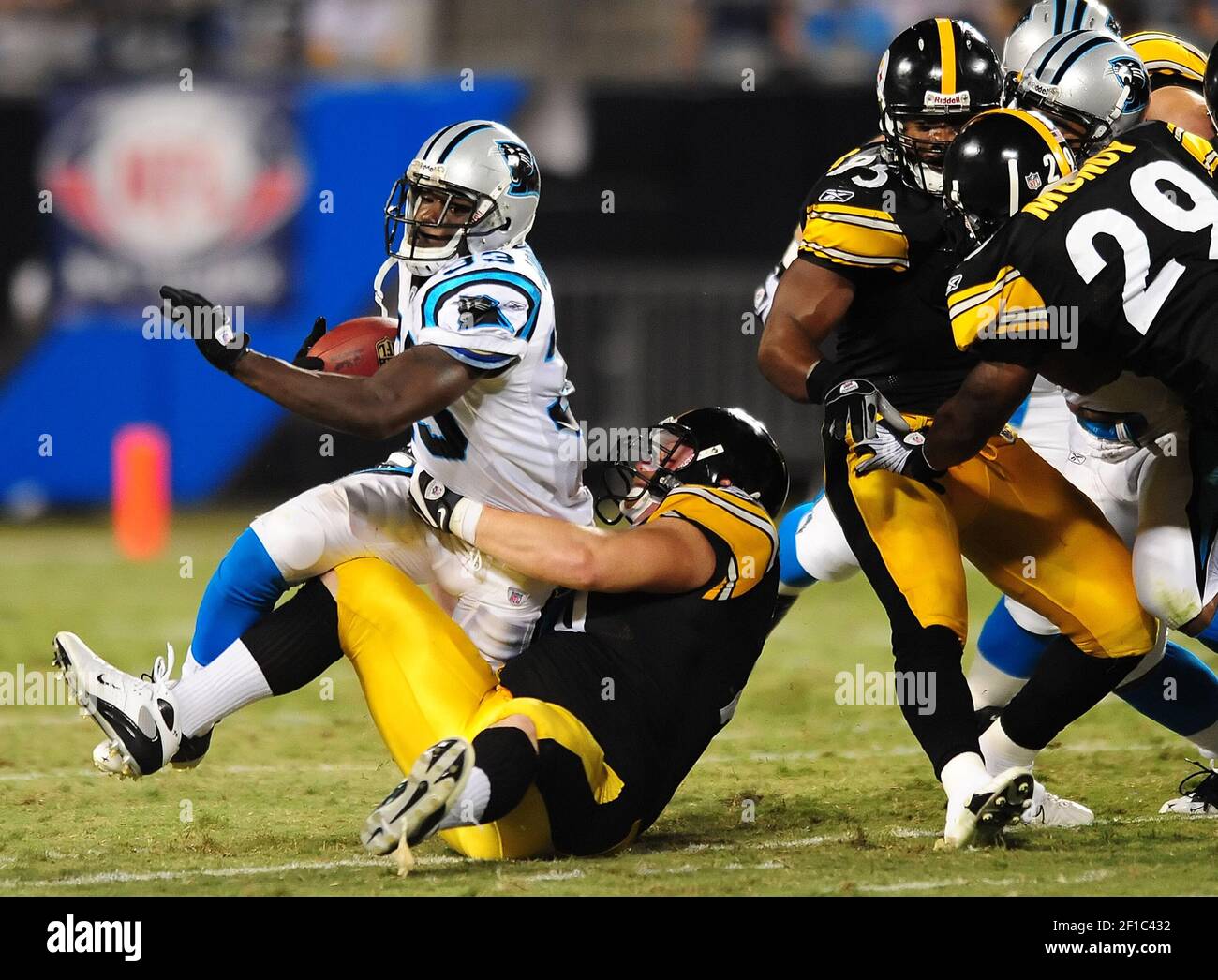 Carolina Panthers running back Mike Goodson (33) gets tackled by a ...