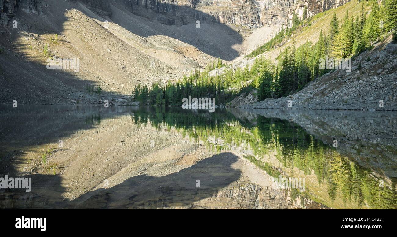 Perfect reflections on beautiful alpine lake, shot at Lake Agnes, Banff ...