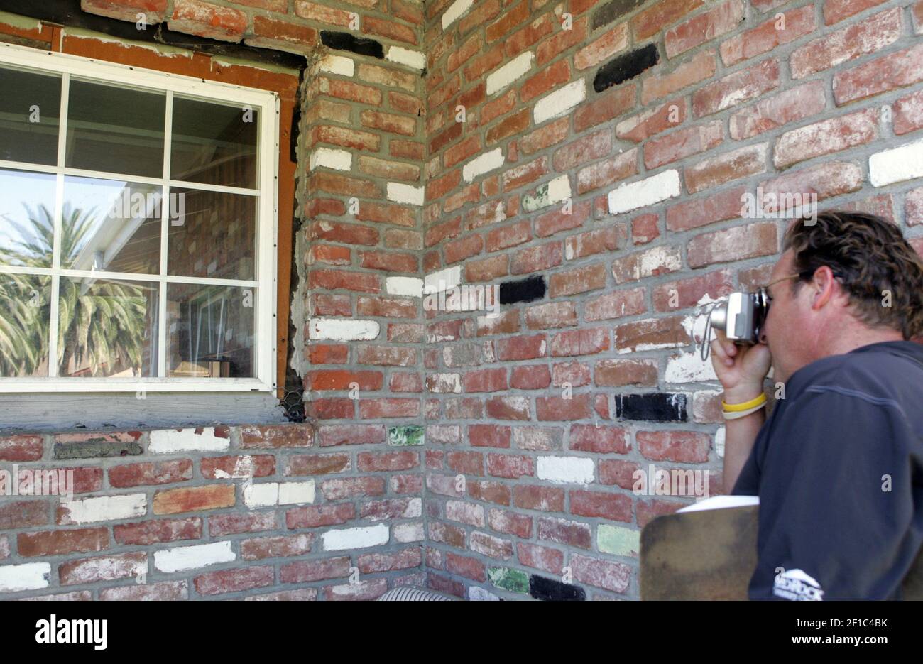 Appraiser John Montgomery takes photos of an unfinished window frame at ...