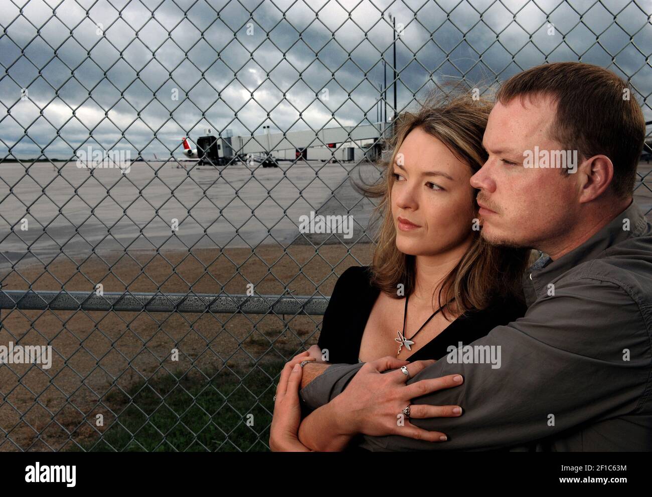 Alysha Johnson and her husband Bill Johnson stand next to the tarmac of ...