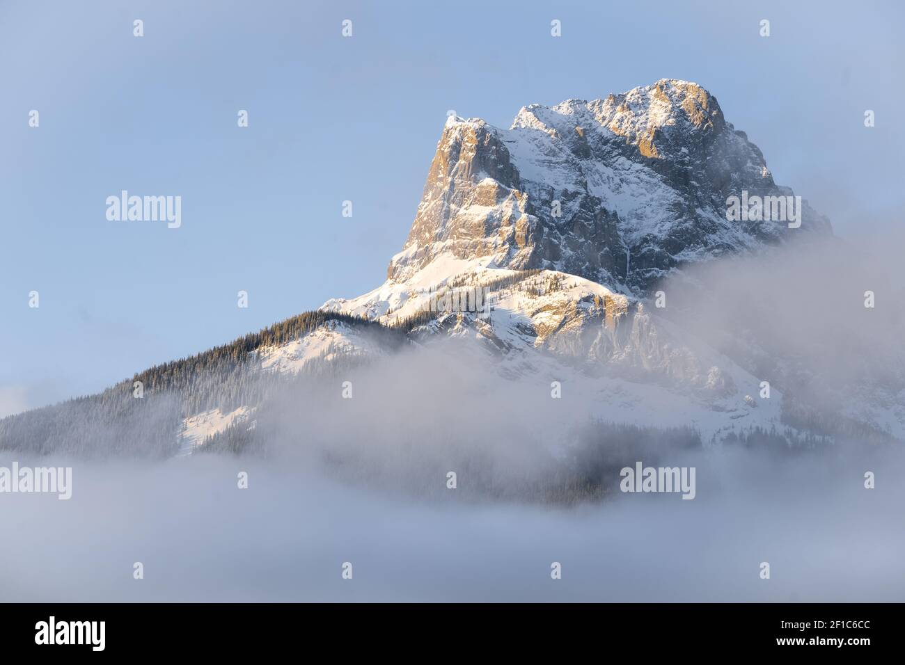 Mountain peak catching first sun rays during sunrise, shot at Three ...