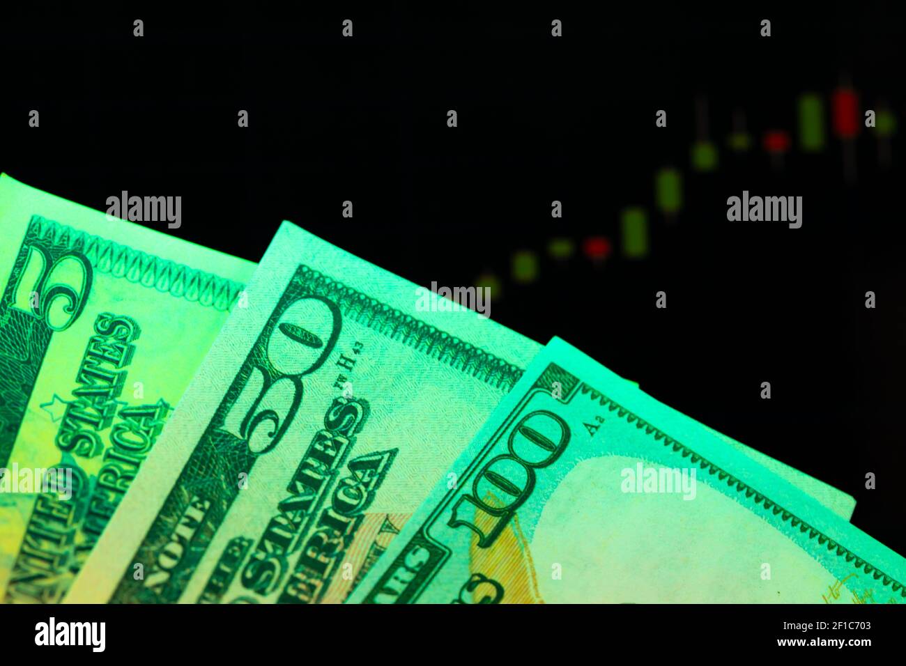 American dollar banknotes and graph on black background Stock Photo - Alamy