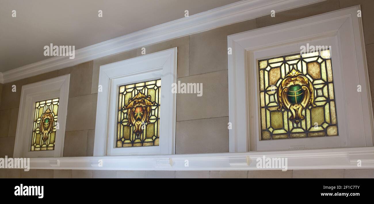 The three stained-glass windows open to a hallway that in turn has ...