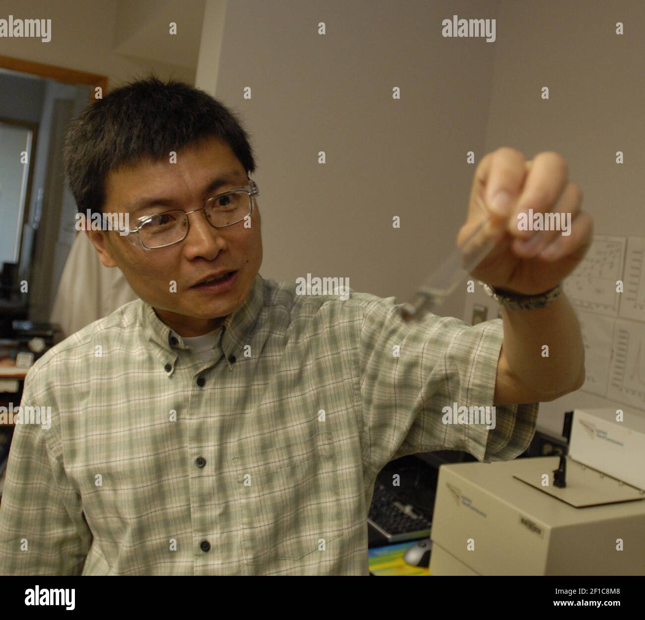 Ming Zheng looks at a nanotube sample used in his DNA sequencing ...