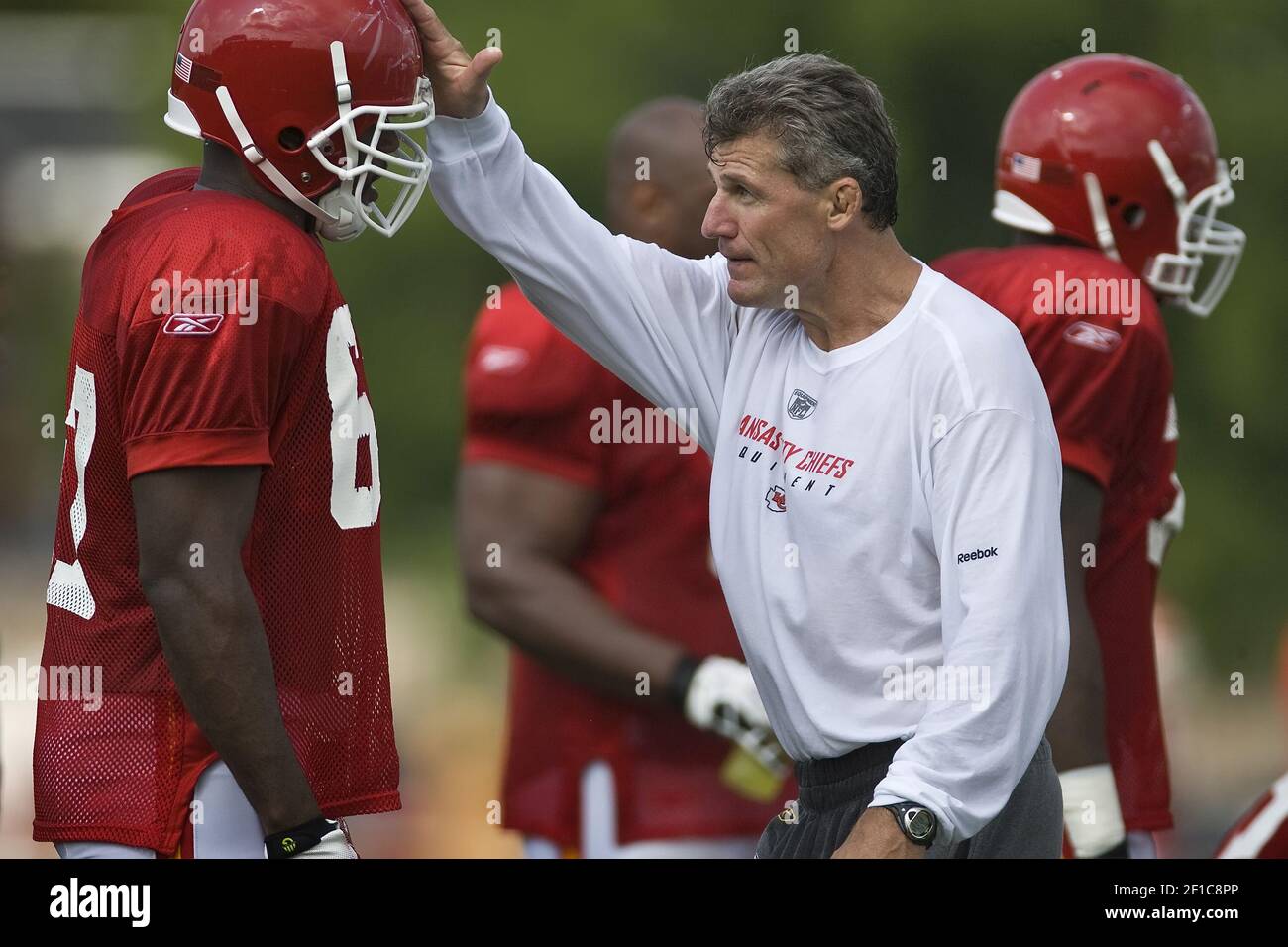 Kansas City Chiefs defensive line coach Tim Krumrie, center, patted ...