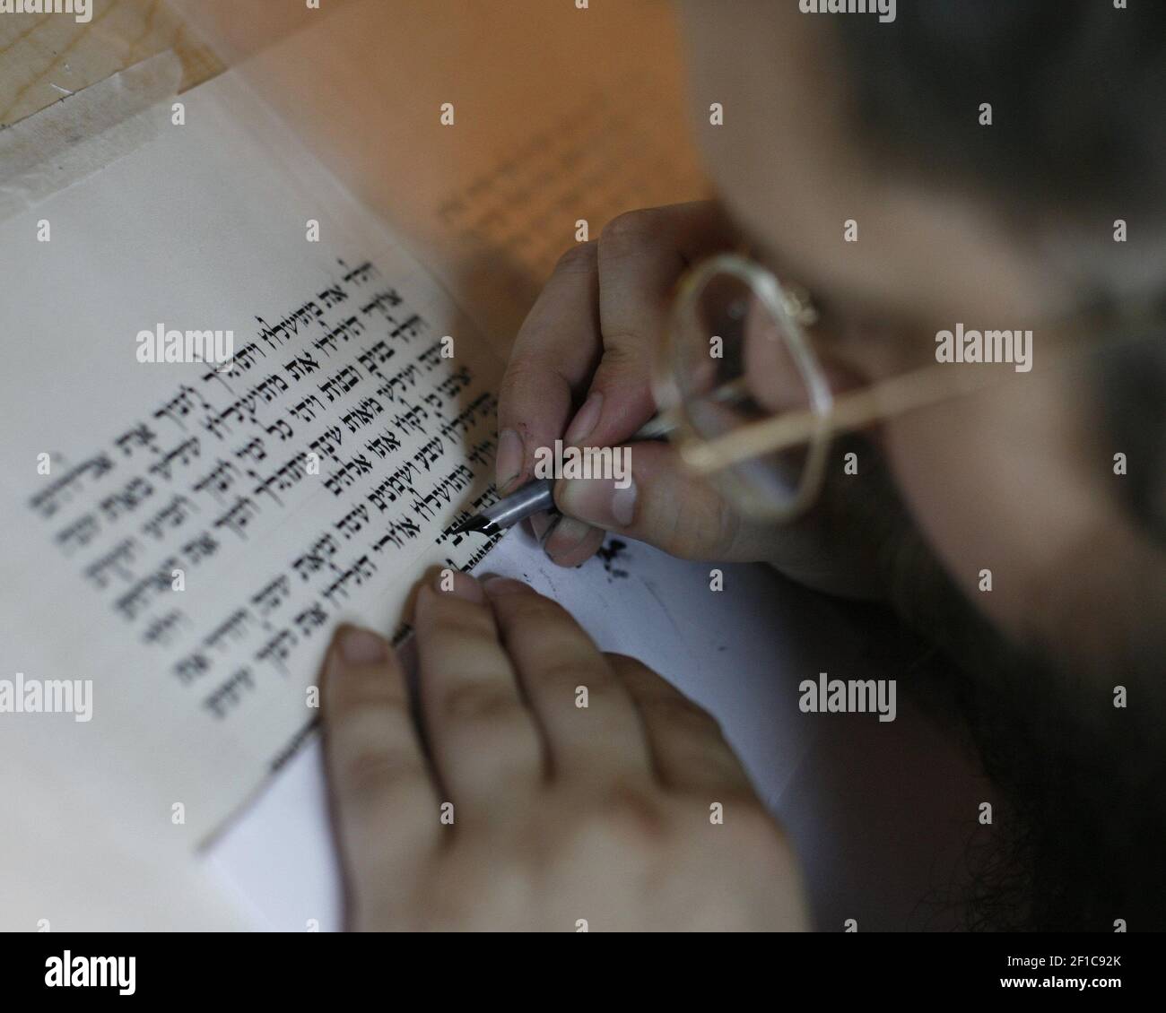 Rabbi Avraham Bloomenstiel works meticulously using traditional Jewish ...