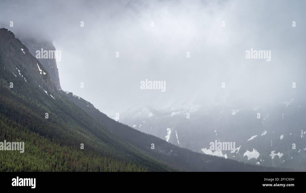 Storm clouds rolling into alpine valley, shot at Upper Kananaskis Lake ...