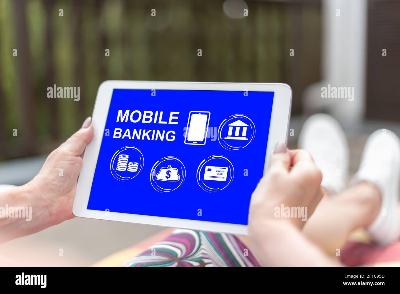 Female hands holding a tablet with mobile banking concept Stock Photo ...