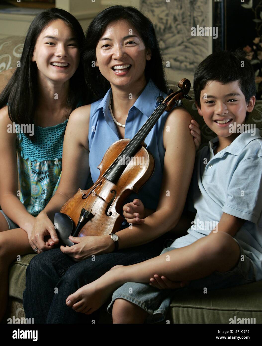 Violinist Elizabeth Suh Lane poses for a photo with her children ...