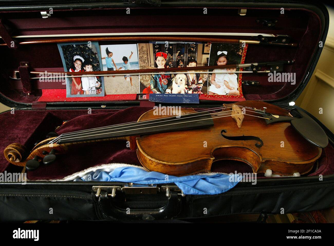 Elizabeth Suh Lane carefully stores her prized violin, a Paolo Testore ...