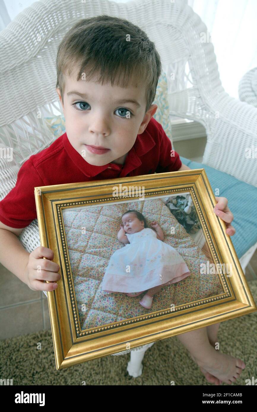 Four-year-old Luke Reimer, of Batavia, Illinois, holds a photograph ...