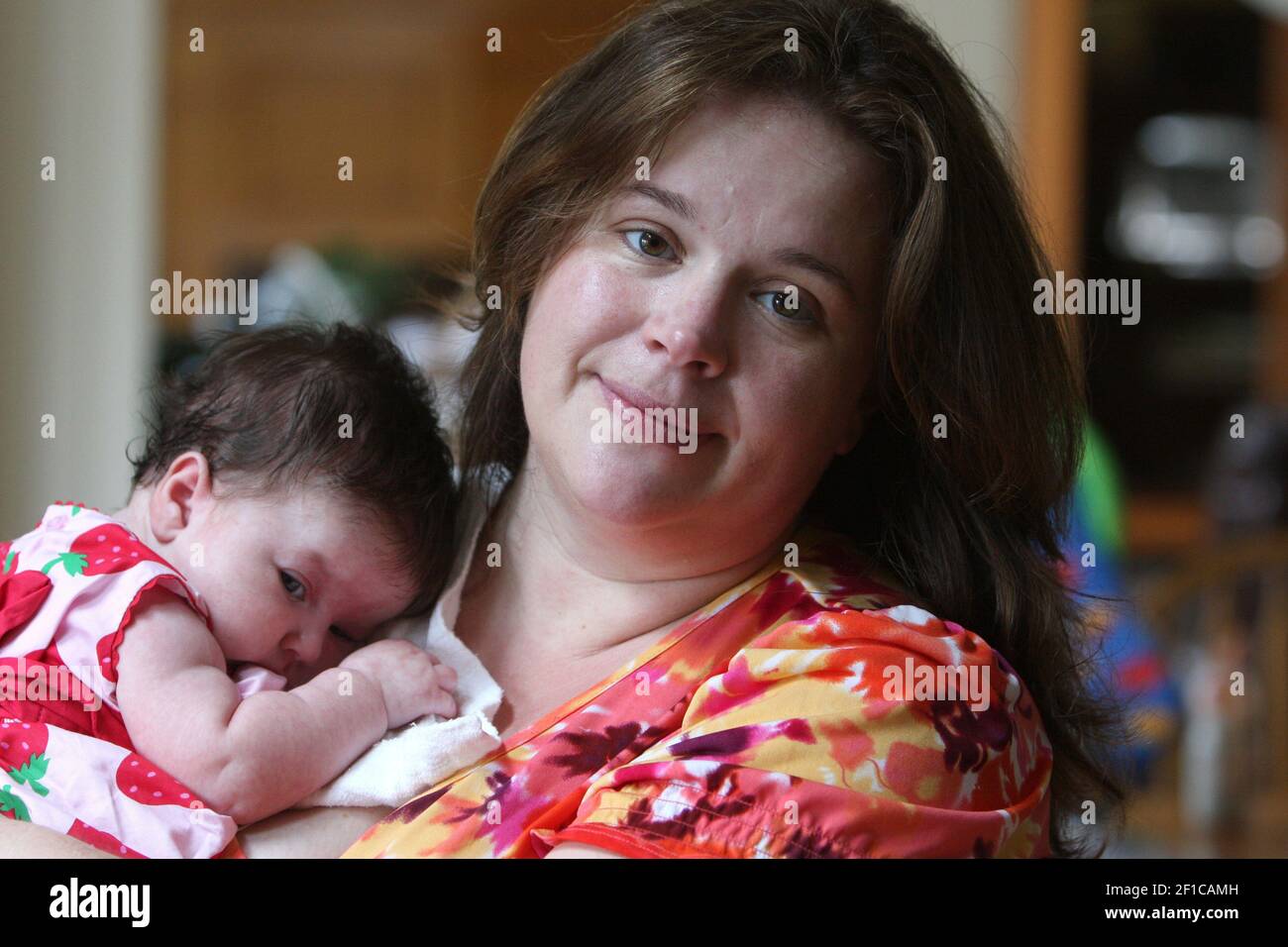 Beth Reimer, poses for portrait with her two-month-old daughter Emma ...
