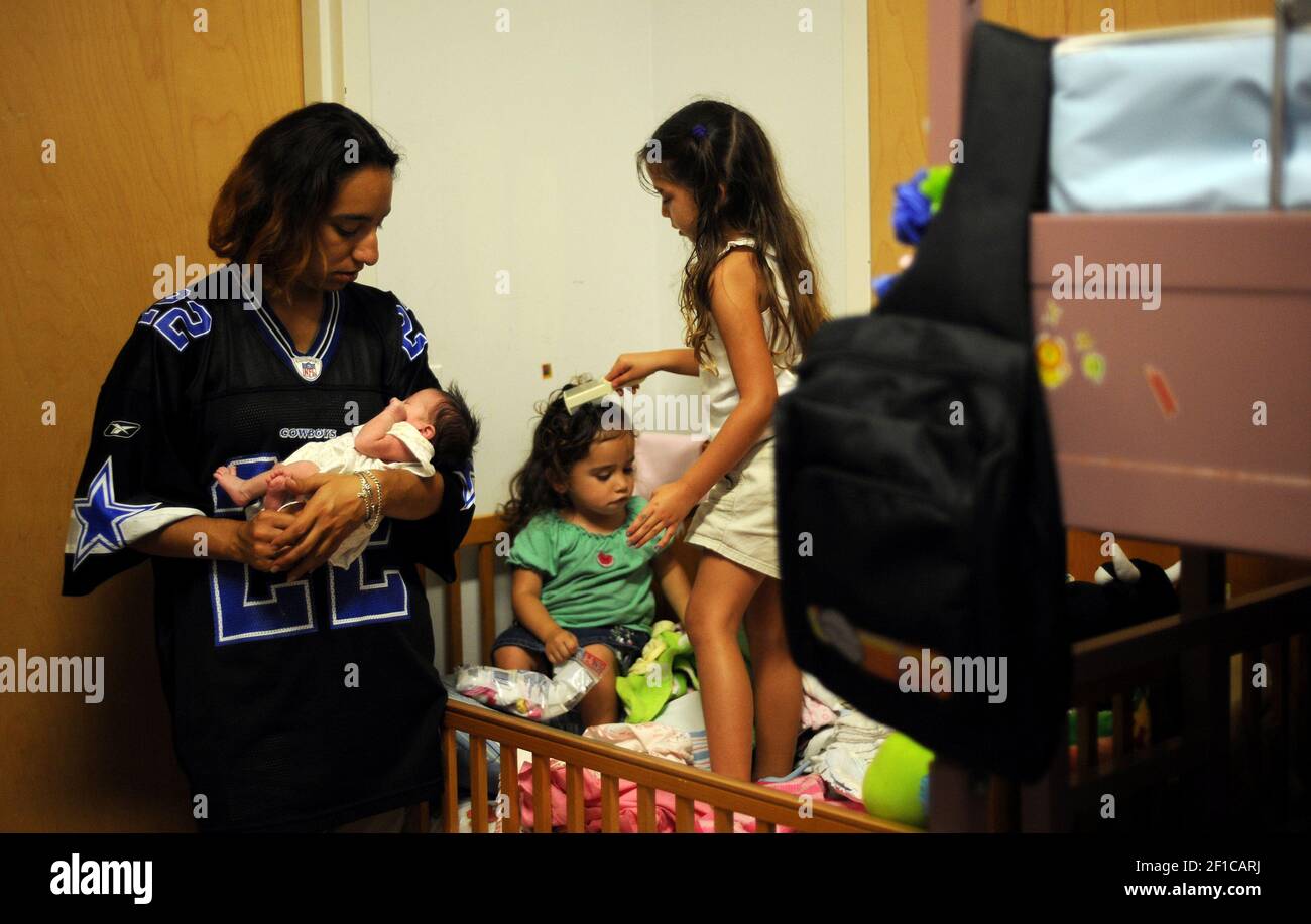 Angela Garcia, left, holds Anastasia Garcia, 9 days old, as Alexis ...