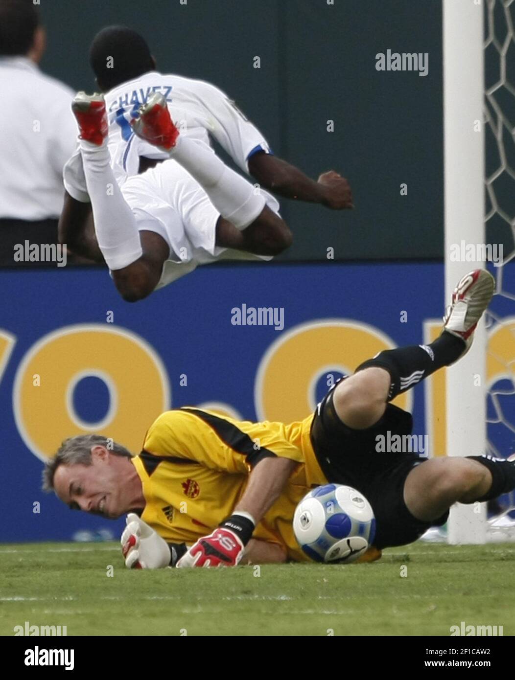 Canada goalkeeper Greg Sutton makes a save as Honduras player Marvin ...