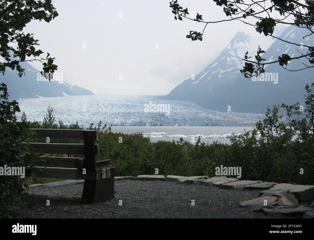 A bench affords a view of Spencer Glacier along the trail from the ...