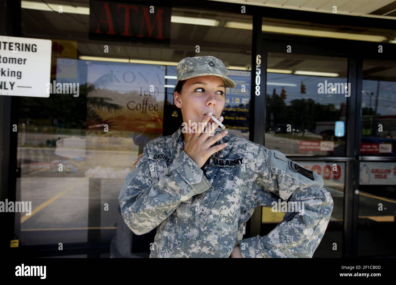 Army PFC Bianca Sandifer smokes a cigarette after buying a pack of ...