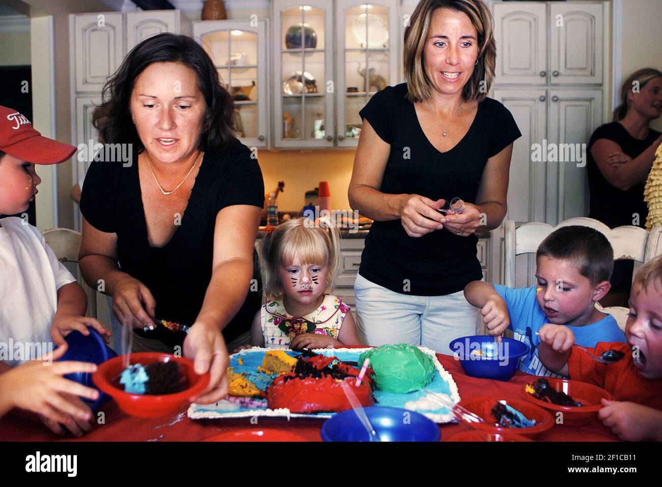 Christine Gesme (left) and Debbie Larson dole out cake at Lauren Gesme ...