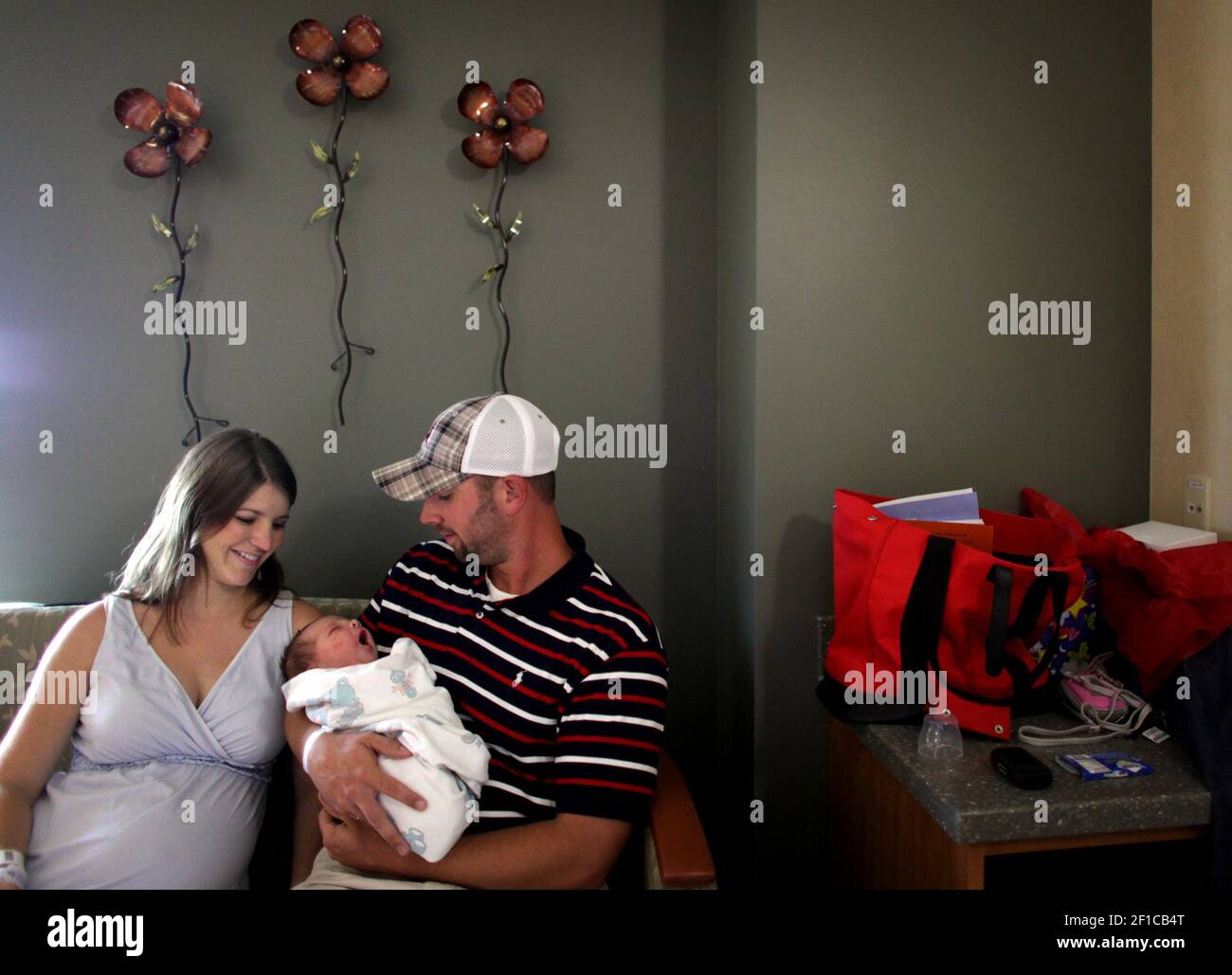 Sonya, left, and Brandon Butorac watch as the one-day-old Brody yawns ...