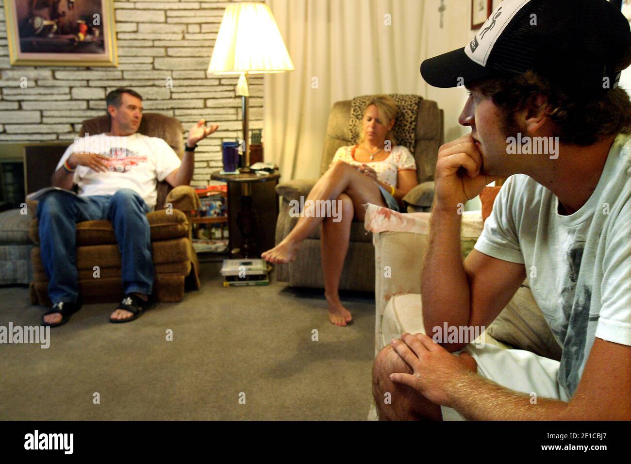 While his parents, Paul, from left, and Paula talk about the accident ...