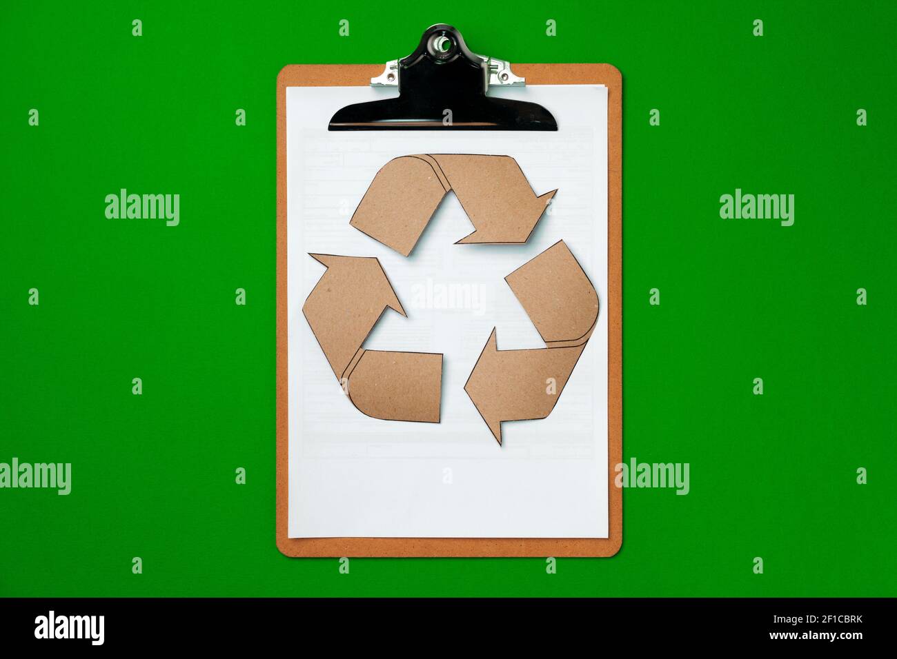 Paper recycling concept on green background top view Stock Photo - Alamy