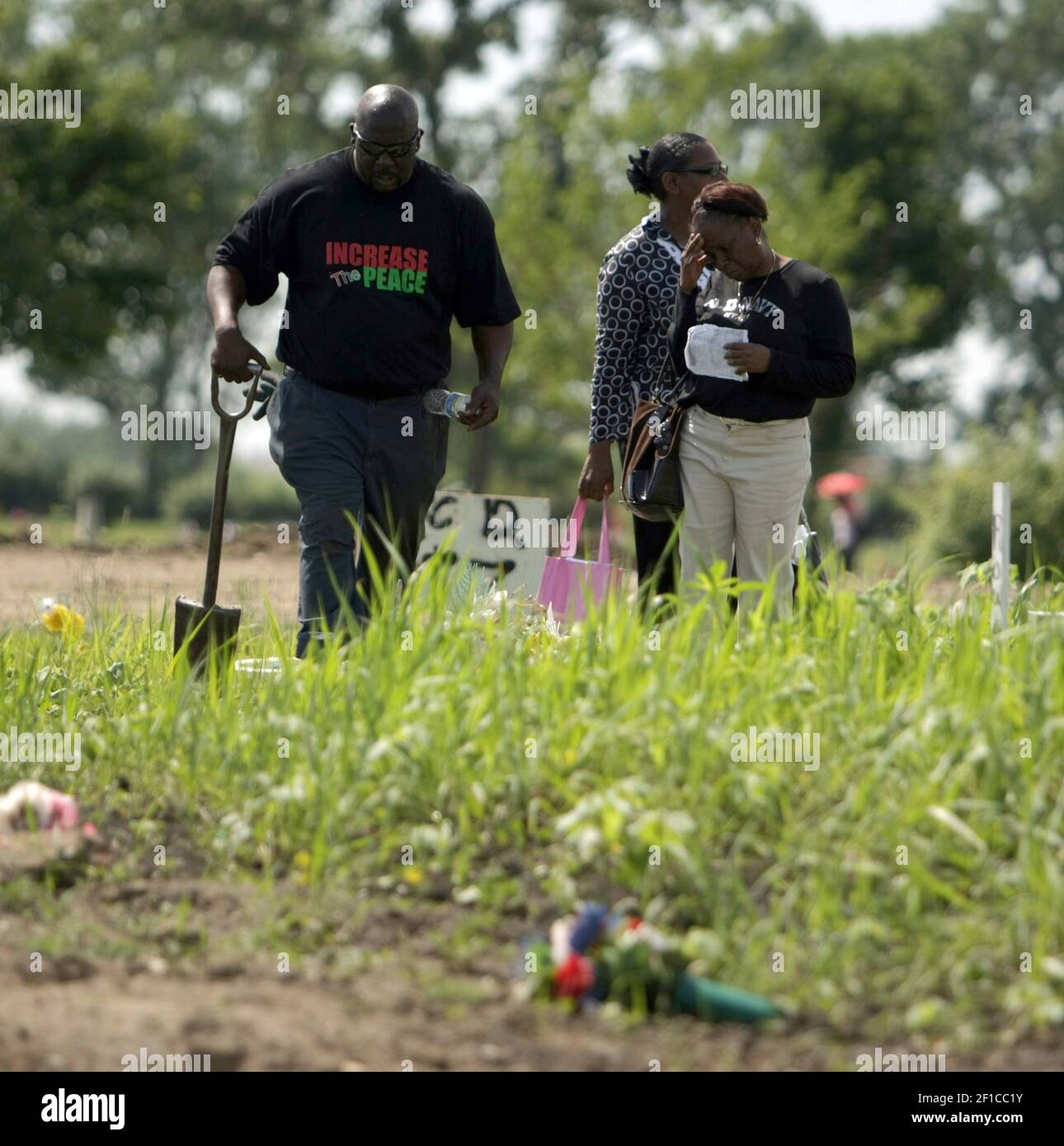 Marissa Redmond, right, becomes upset as she searches for the graves of ...