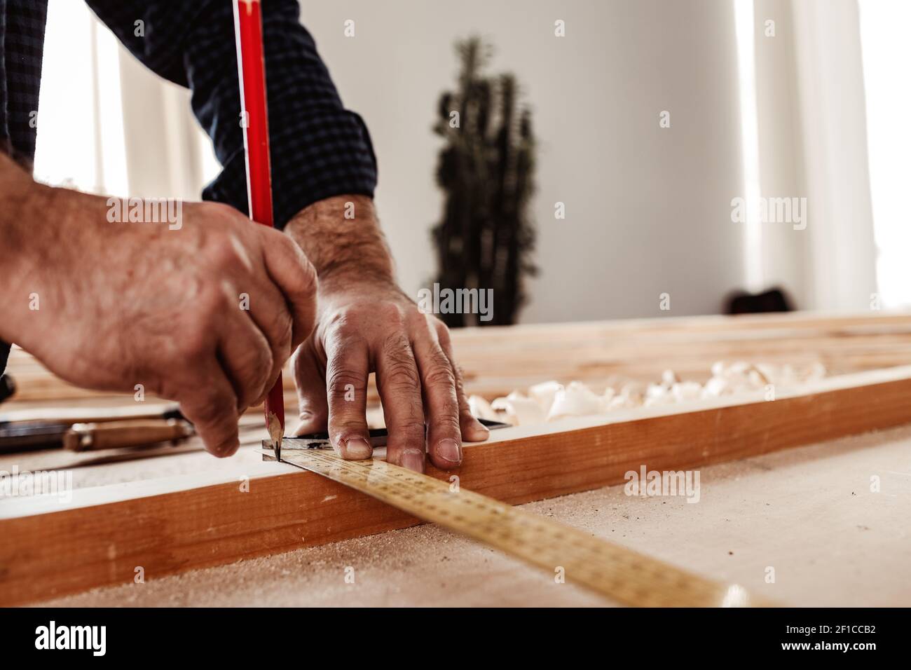 Carpenter makes pencil marks on a wood plank Stock Photo - Alamy