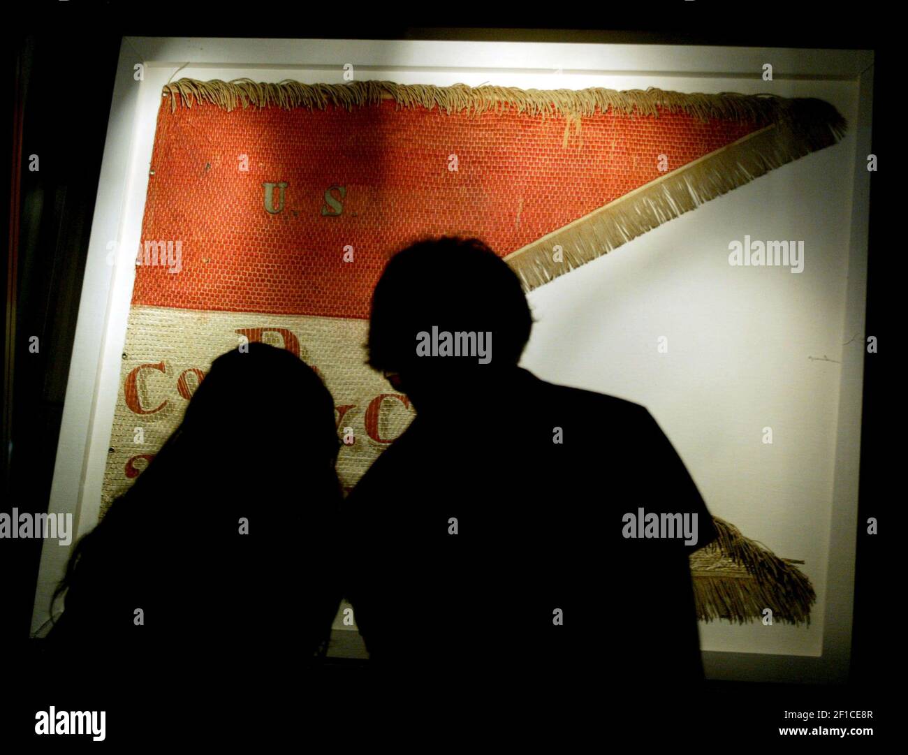 A pair of visitors examine a Company D, Second Cavalry Regiment ...