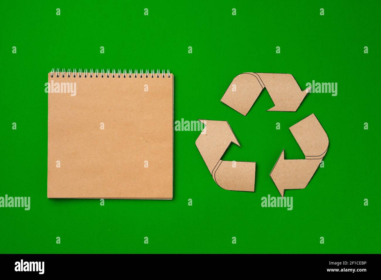 Paper recycling concept on green background top view Stock Photo - Alamy