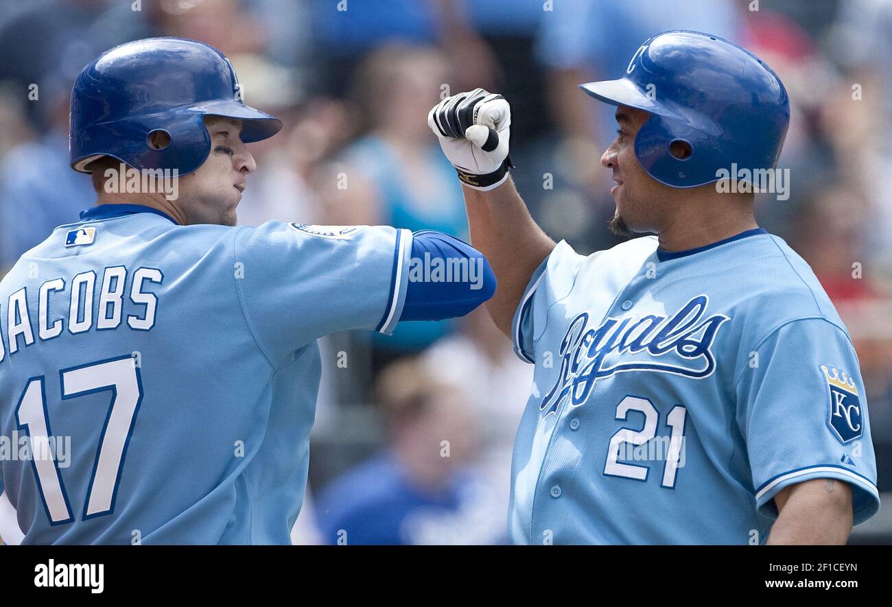 The Kansas City Royals' Miguel Olivo (21) is greeted at the plate by ...