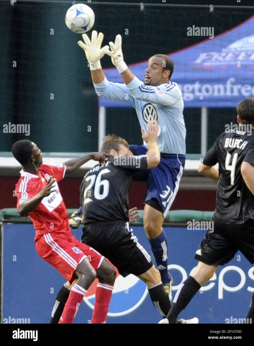 D.C. United goalkeeper Josh Wicks goes high to pull down a Chicago Fire ...