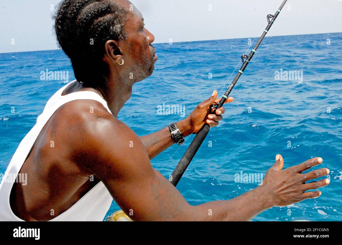 A fish strikes while trolling off of Antigua and Louie reaches for the ...