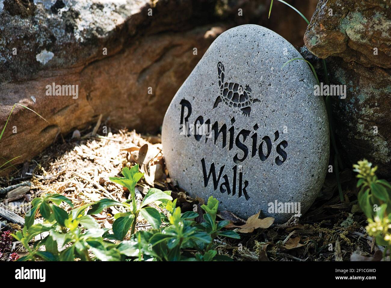 A stone marker honors the man who did much of the Burkes' landscaping ...