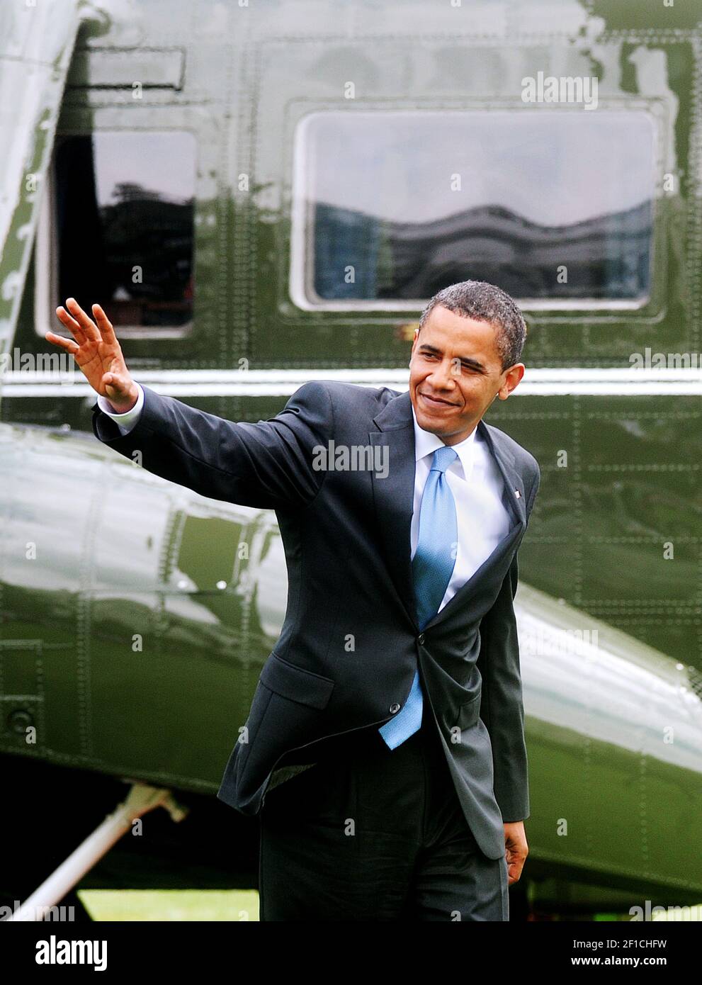 President Barack Obama waves to a crowd as he arrives with Marine One ...