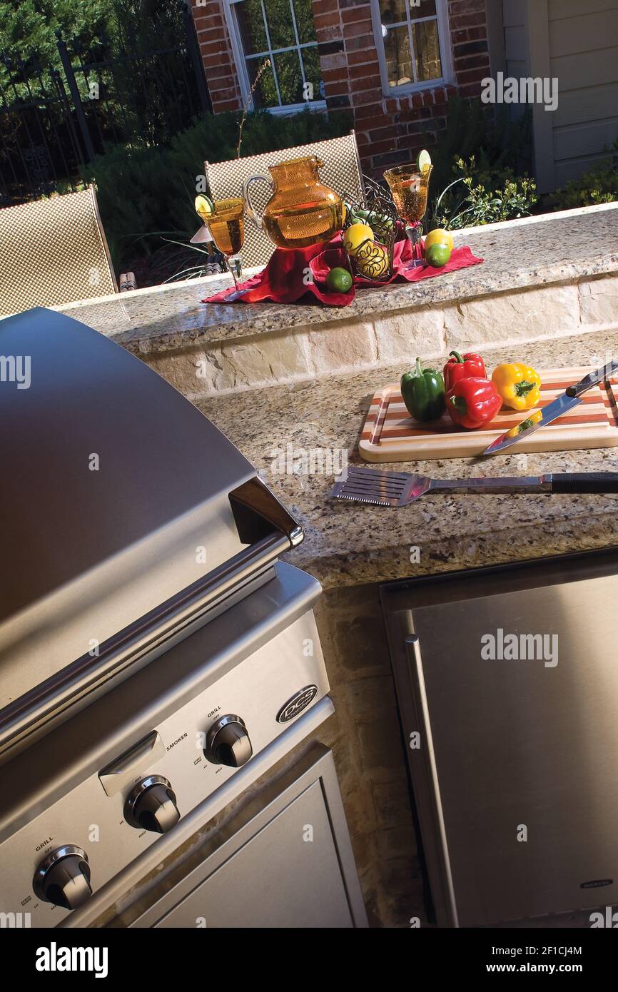 A granite countertop flanks a 36-inch gas grill and built-in outdoor ...