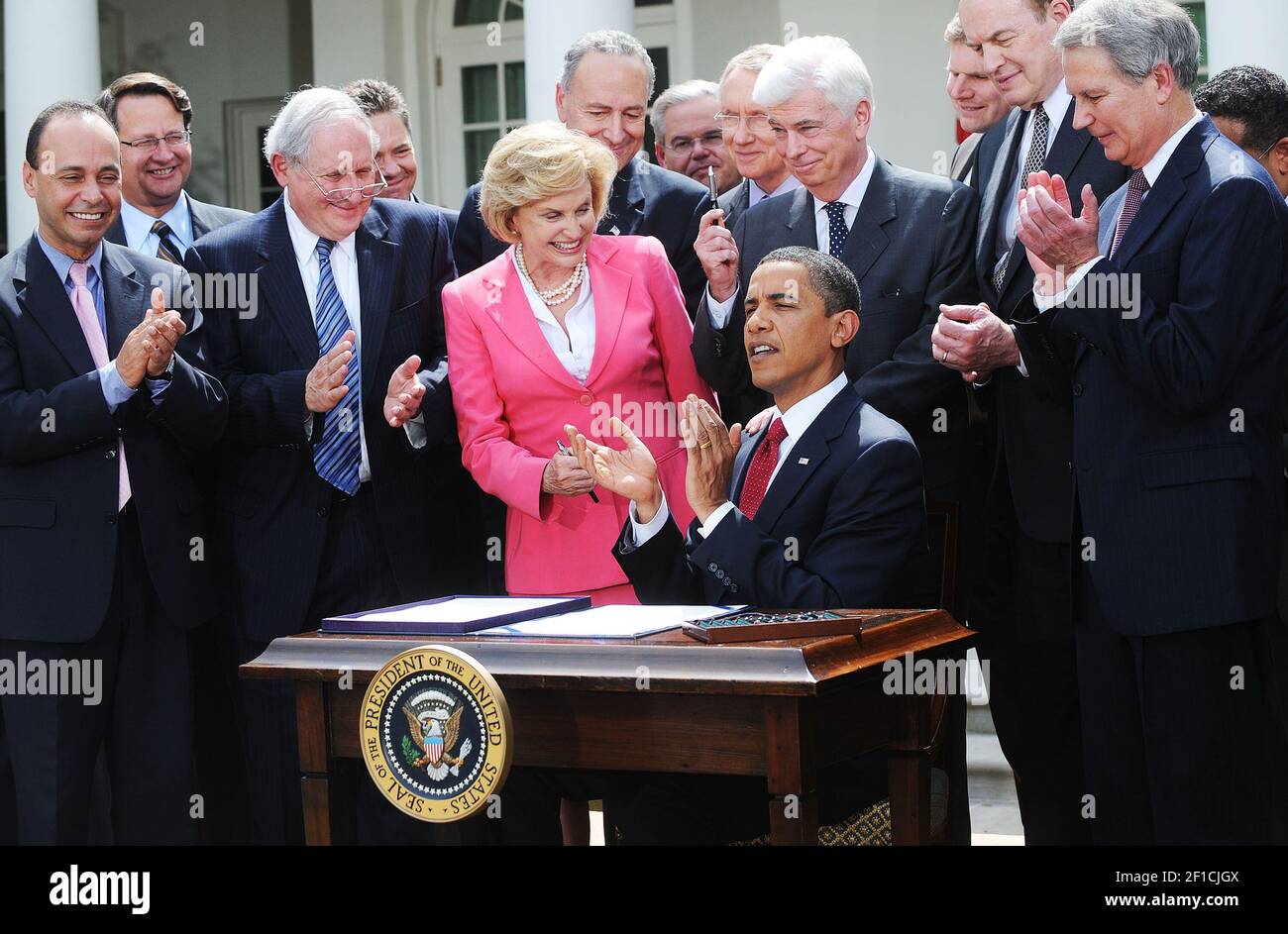 President Barack Obama, flanked by members of Congress, signed the ...