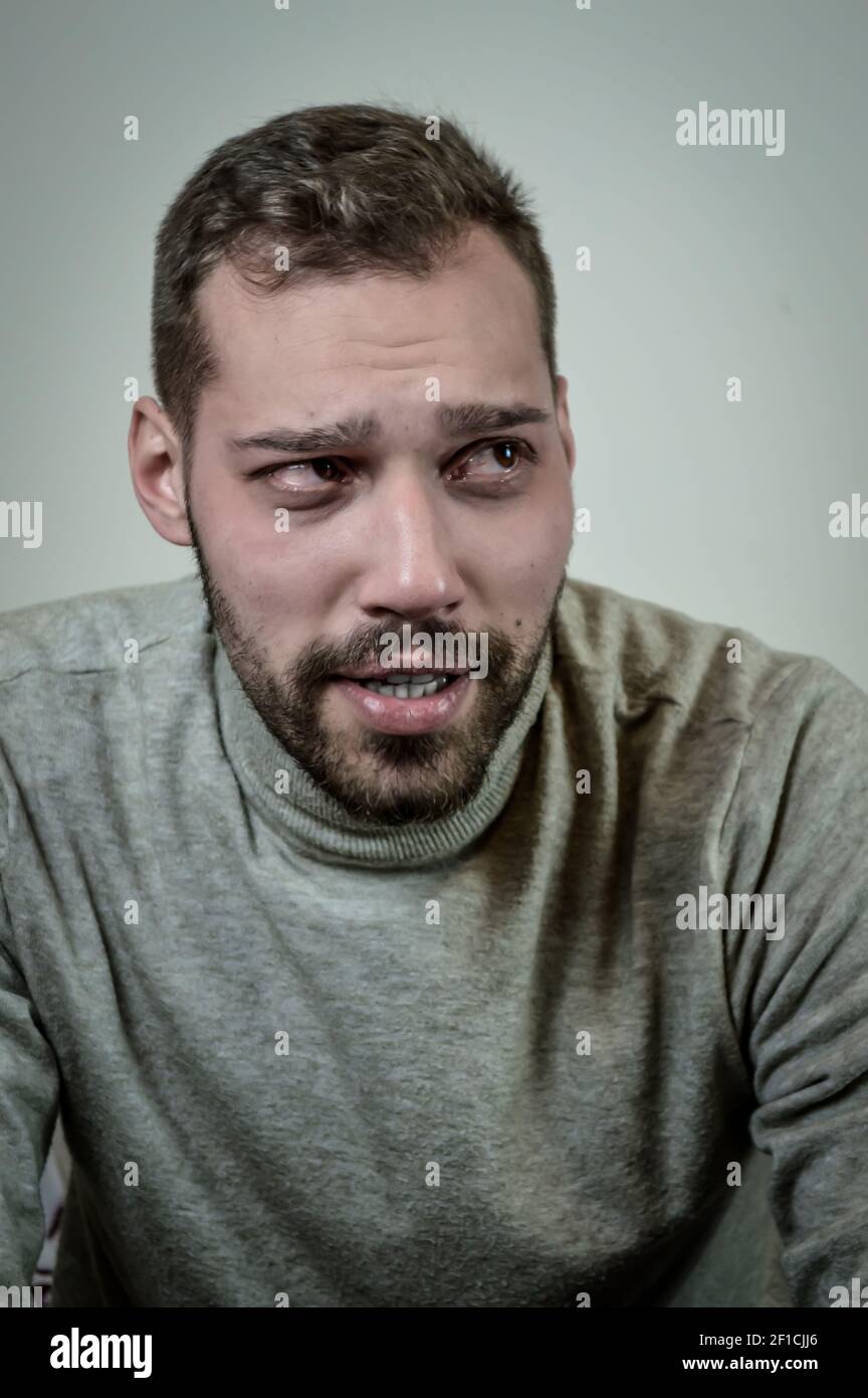 Portrait of a sad young bearded man who is crying Stock Photo - Alamy