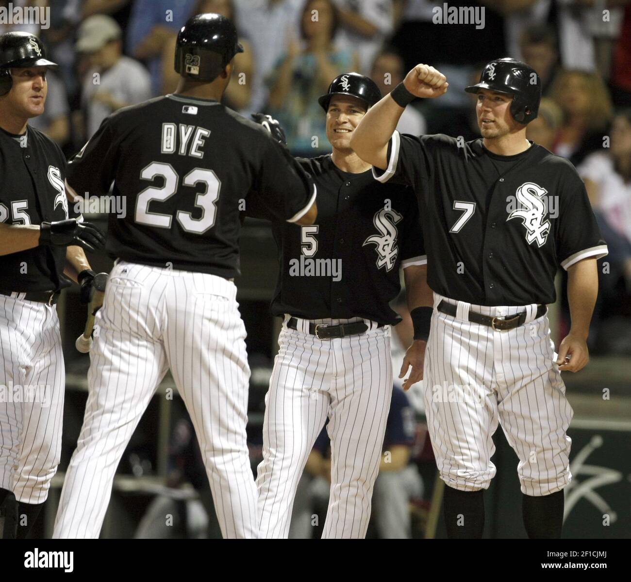 Chicago White Sox's Jermaine Dye (23) is greeted by Jim Thome, Jayson ...