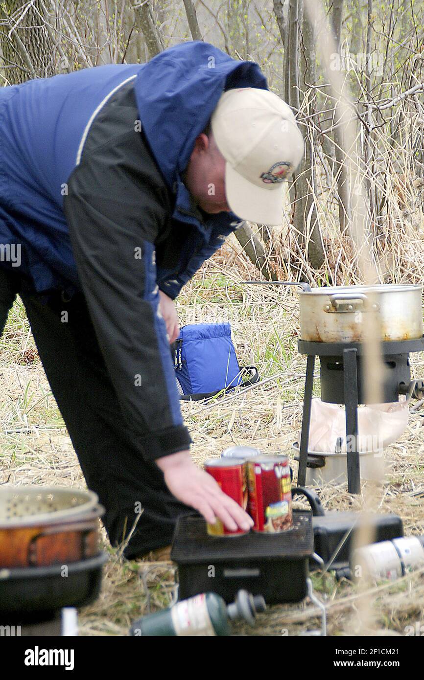 Todd Maas of Duluth, Minnesota, checks the heat under the baked beans ...