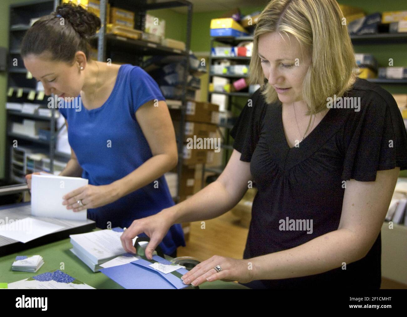 Design consultant Lori Blair, left, and Melissa Windley, right, work on ...